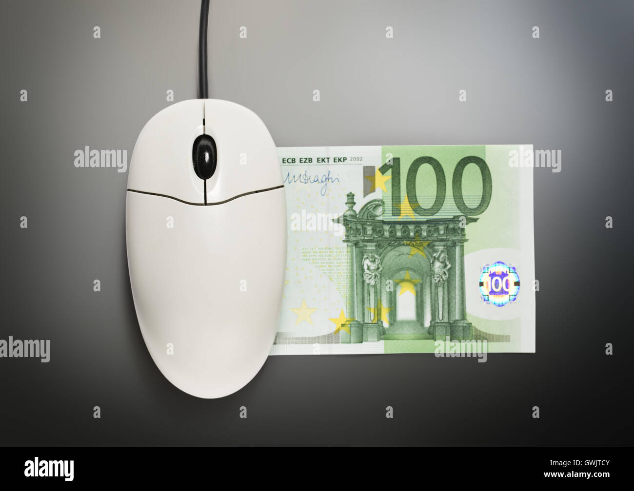 Computer mouse and one hundred euro banknote on gray Stock Photo - Alamy