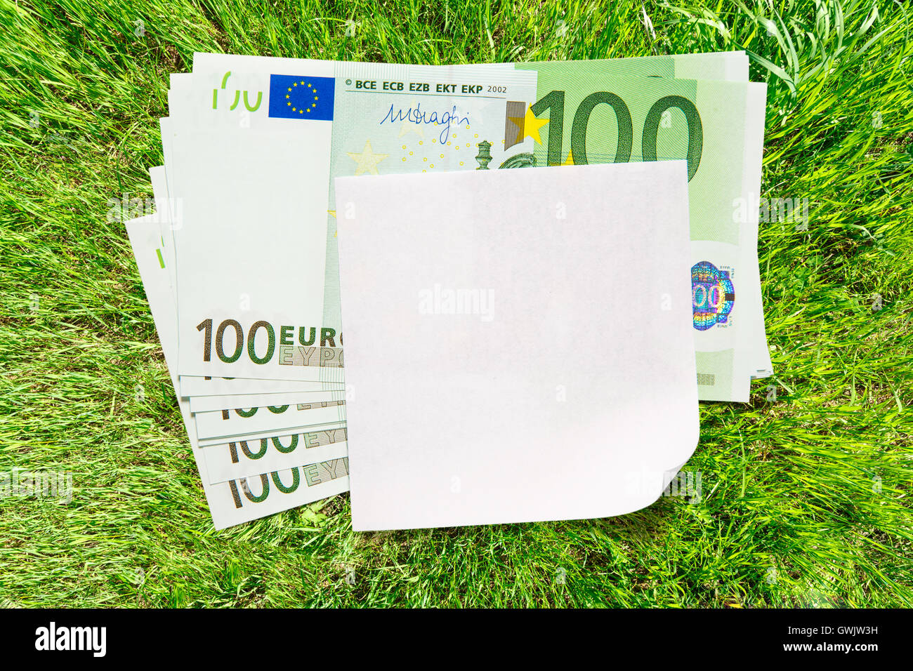 One hundred euro banknotes and blank paper Stock Photo - Alamy
