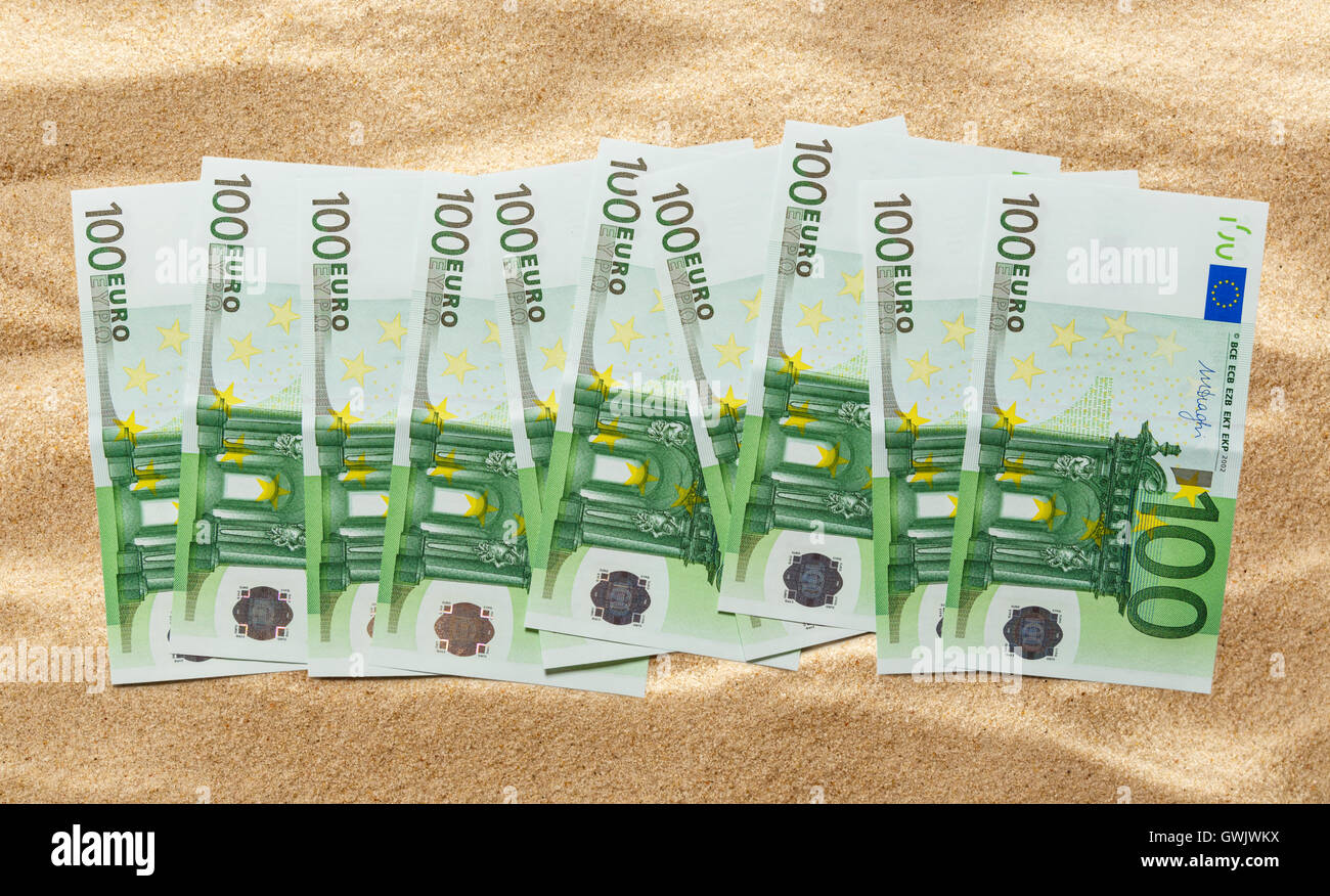 One hundred euro banknotes on sand background Stock Photo - Alamy
