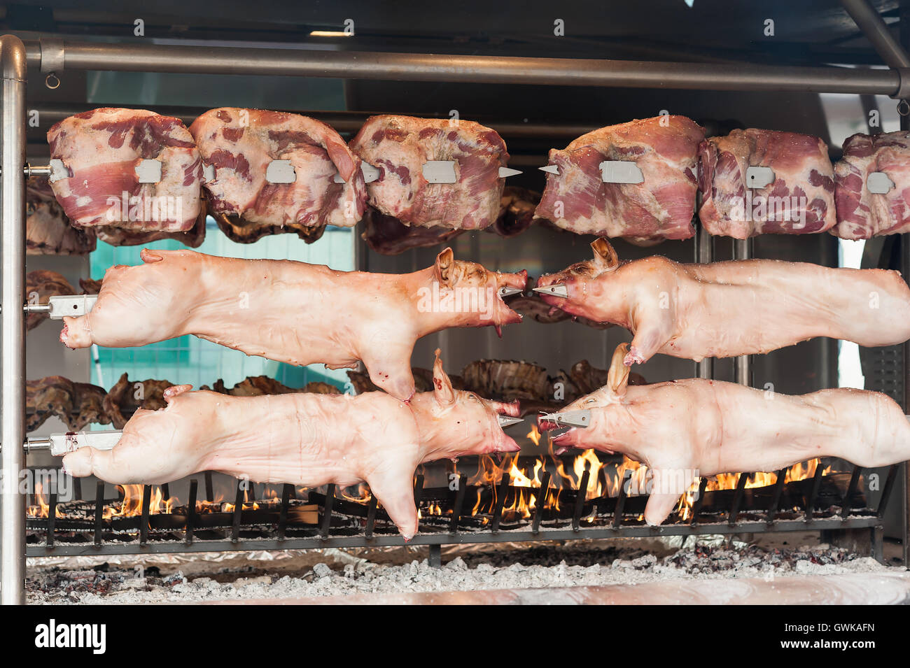 Carcasses of pork and other meat prepared on skewer. Cooking on grill ...