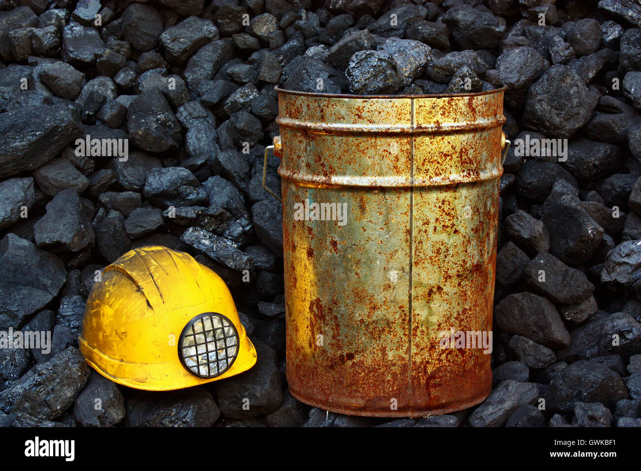 Bucket of coal and helmet coal miner Stock Photo - Alamy