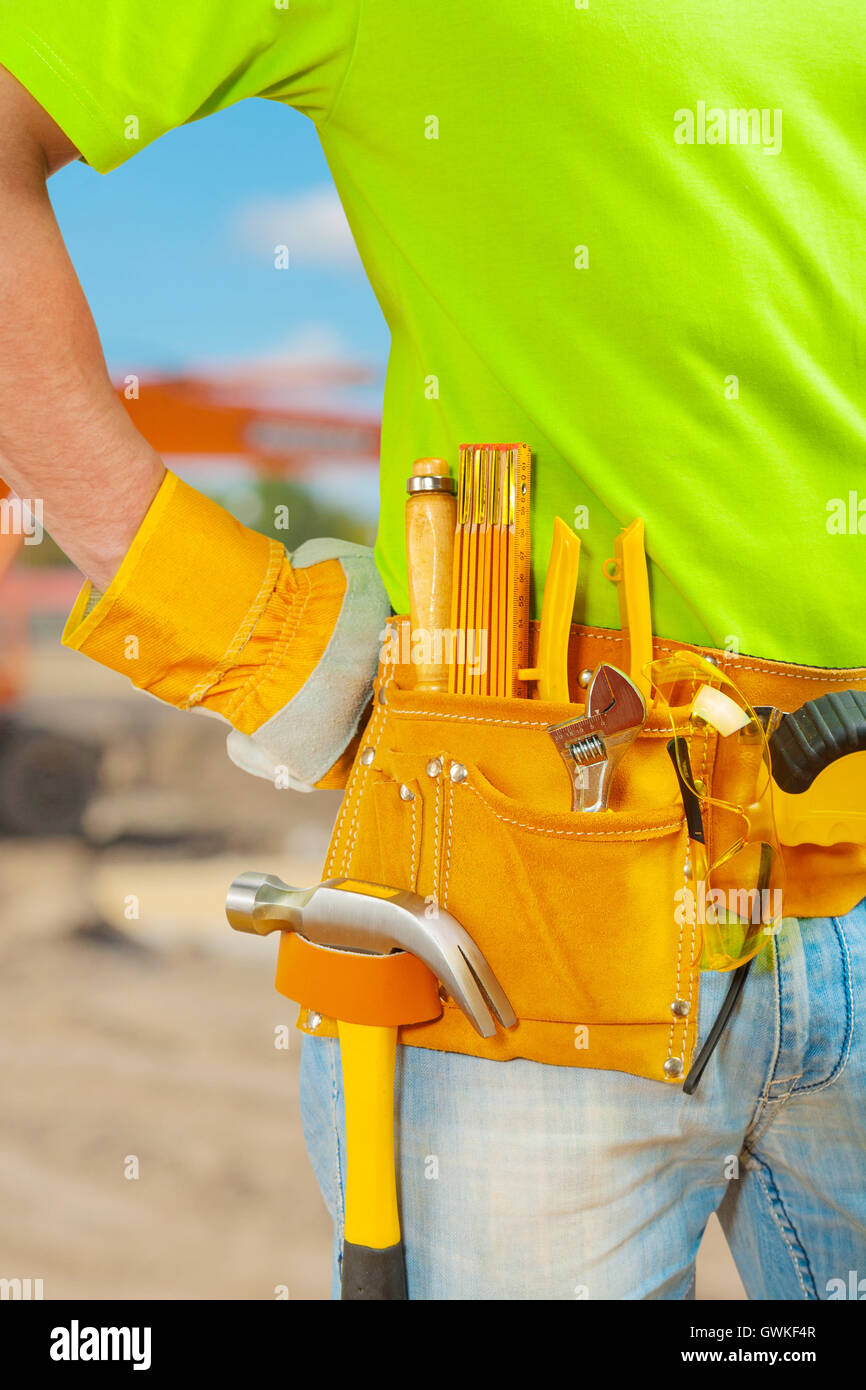 worker with tools in belt Stock Photo - Alamy
