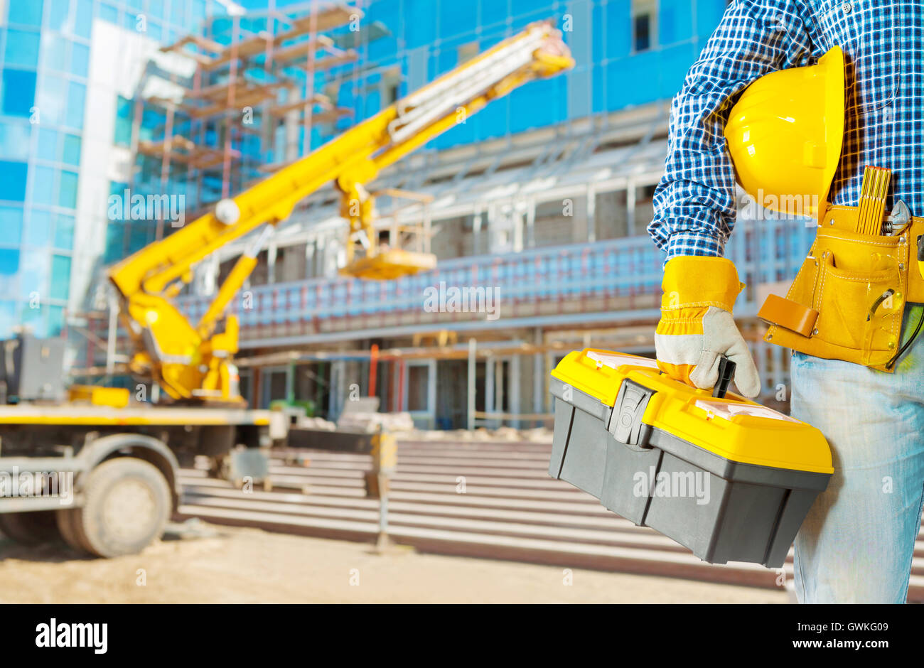 contractor with tools on construction site Stock Photo - Alamy