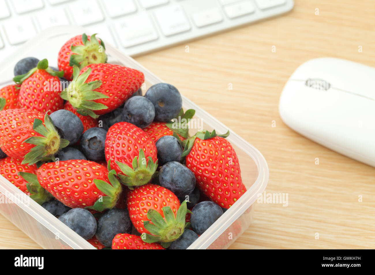 Berry mix lunch box in working desk Stock Photo - Alamy