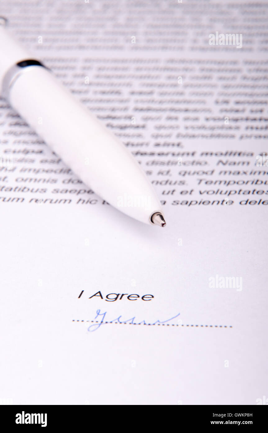 Signature over agreement Stock Photo - Alamy