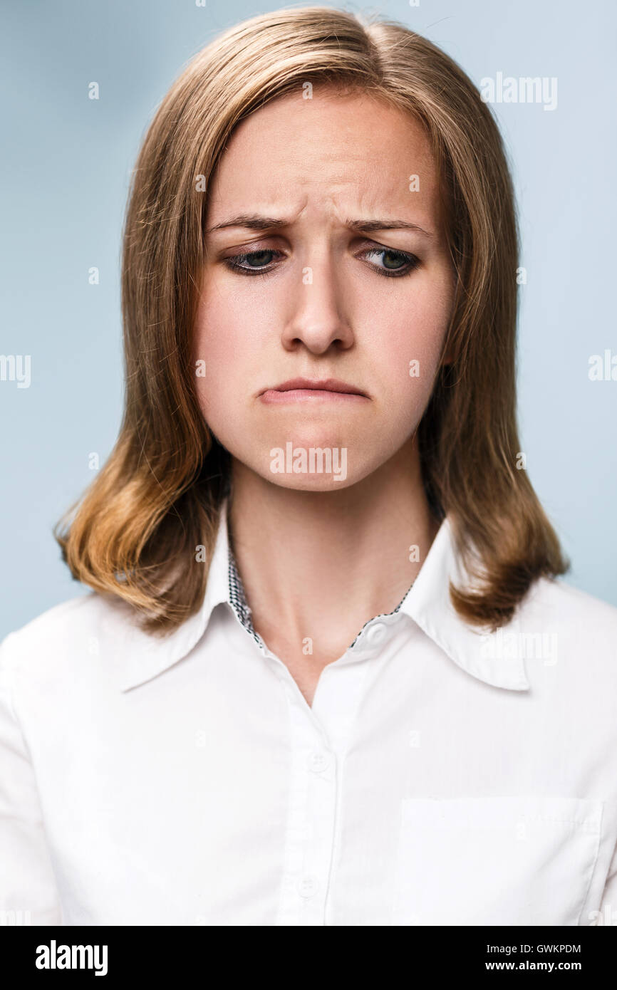 Young woman doing a pout expression over gray background Stock Photo ...