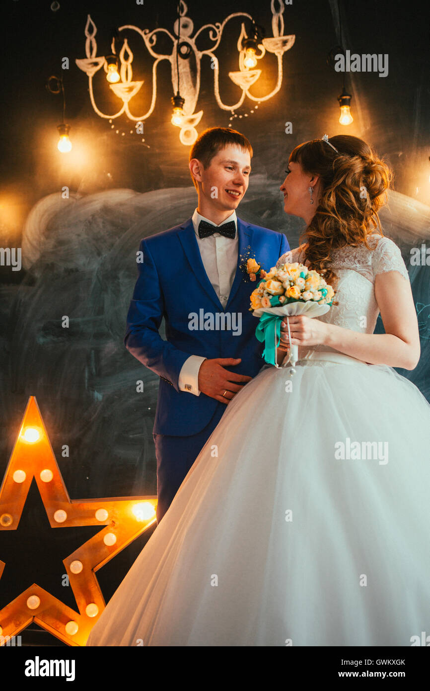bride and groom in the interior of the studio are on the background ...