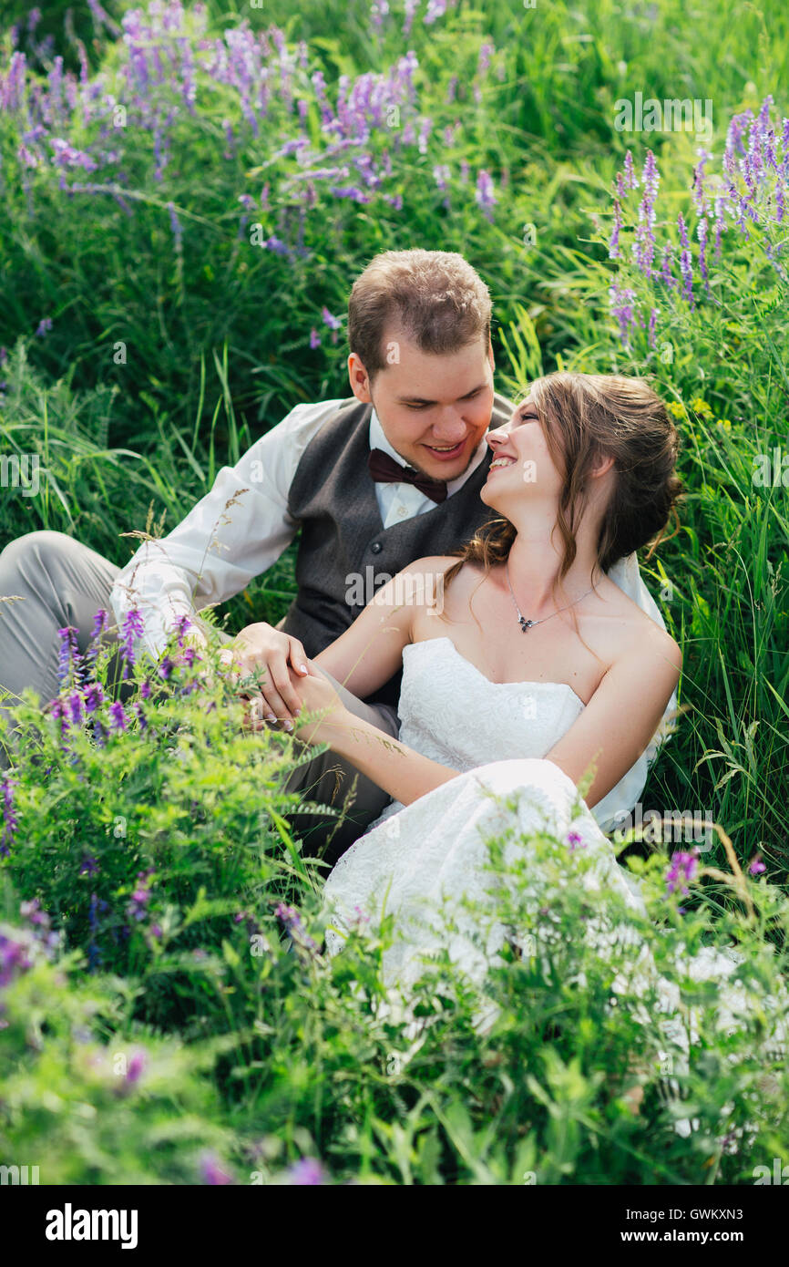 portrait of the bride and groom resting on a lavender background Stock ...