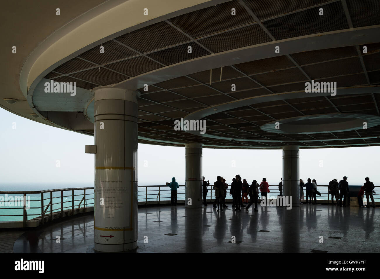 Silhouette of tourists at the Taejongdae Resort Park's observation deck ...