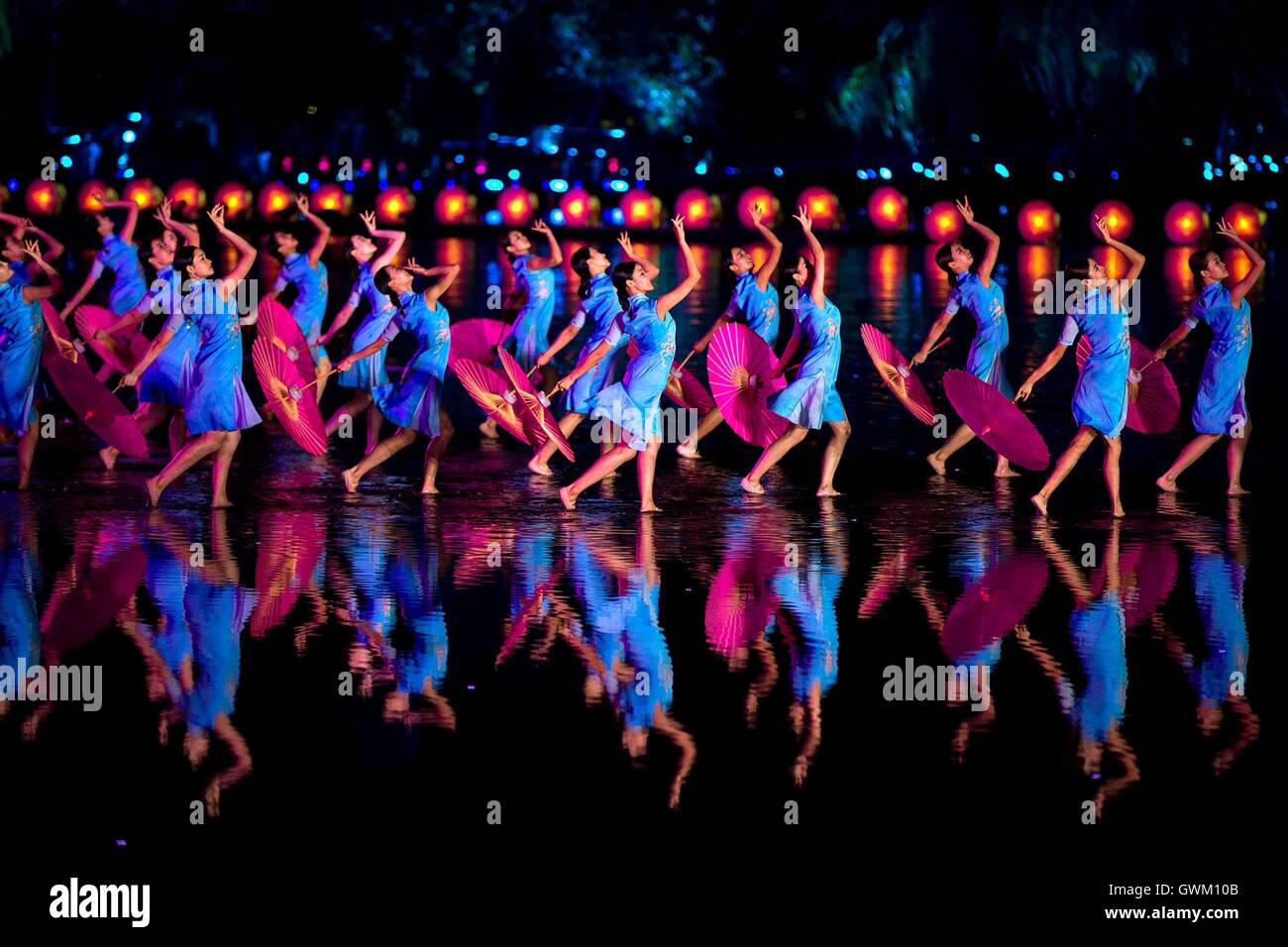 Performers appear to dance on water during a gala dinner performance ...