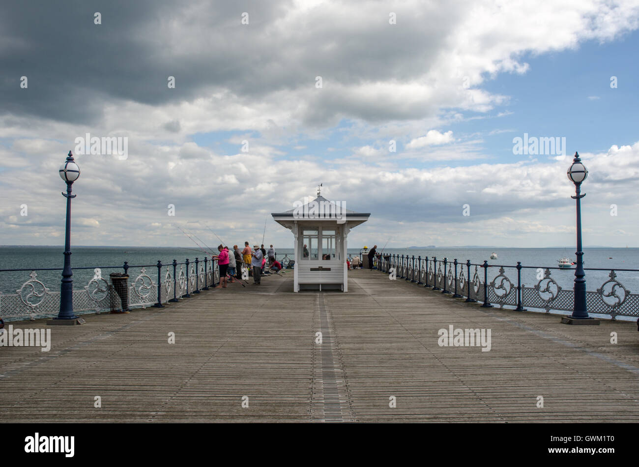 People fishing by a shelter on Swanage pier Stock Photo - Alamy