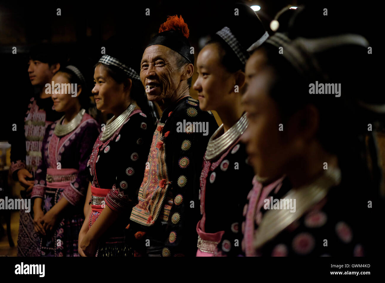 An elderly man with young girls in traditional garment during Hmong ...