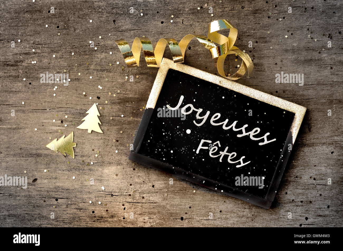 little sign with message happy holidays written in french on wooden ...