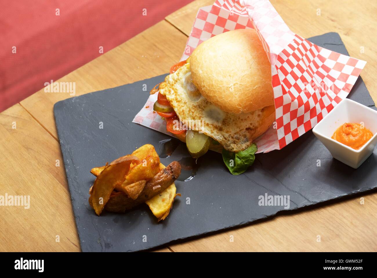 Beef burger with fried egg and chips Stock Photo - Alamy