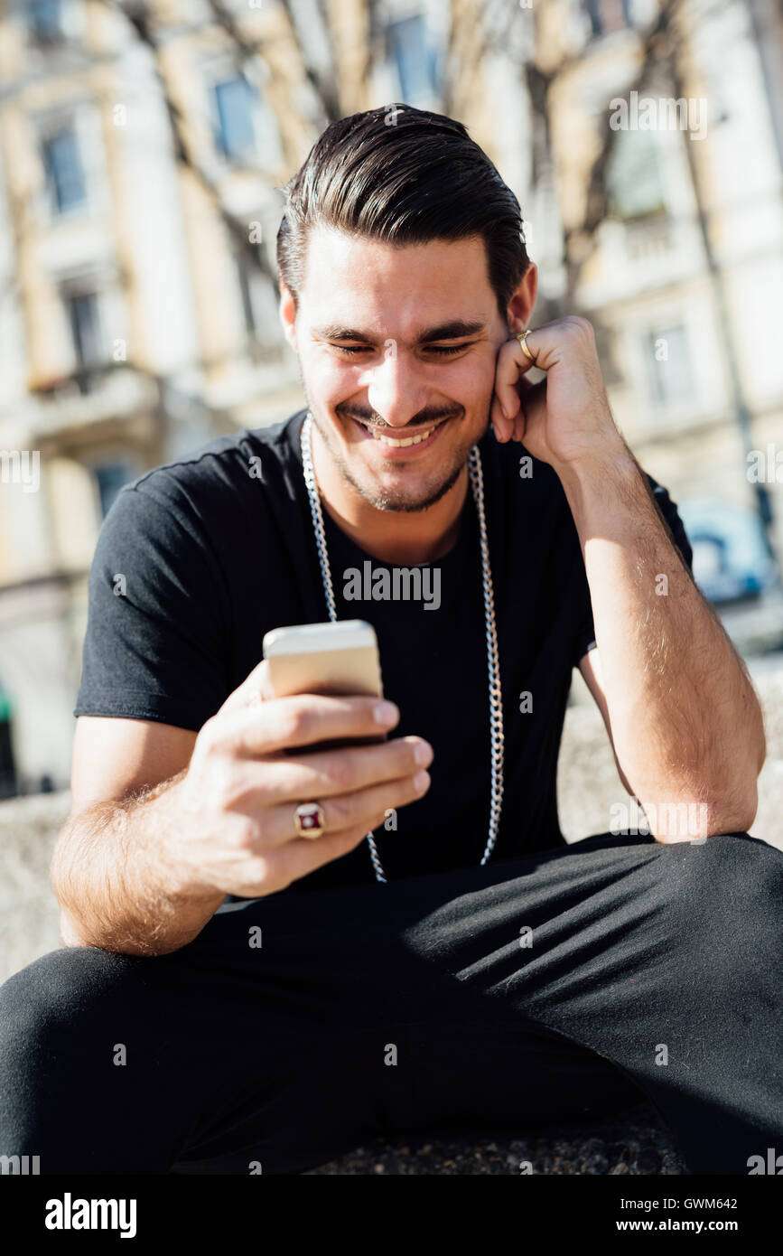 Man tapping smartphone on sidewalk hi-res stock photography and images ...