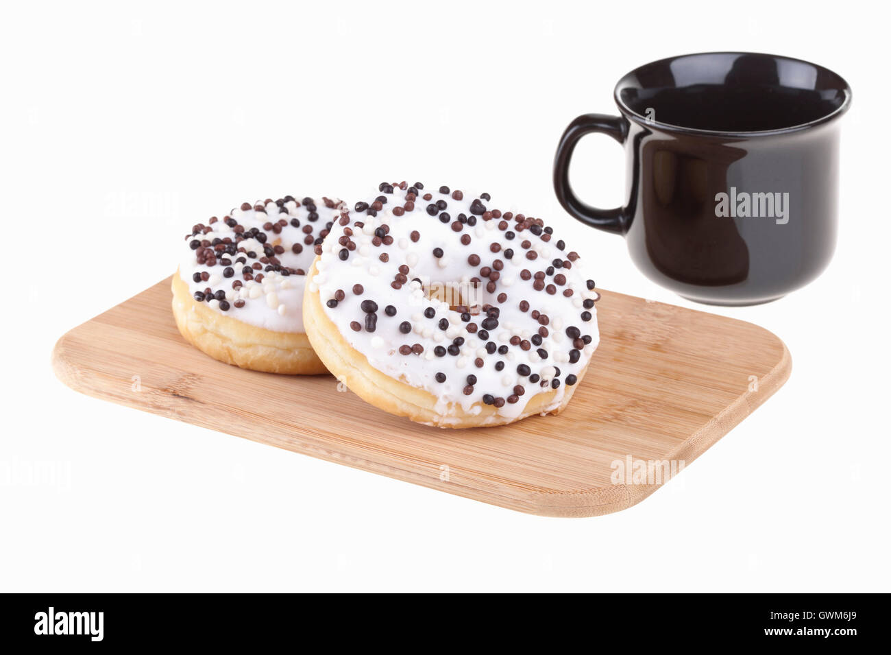 Studio photo of tasty donuts on a wooden desk with a cup of coffee ...
