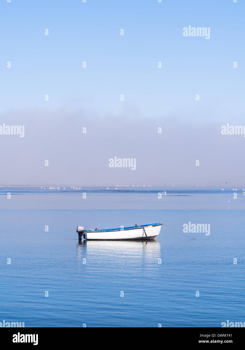 Single boat on the Atlantic Ocean in Walvis Bay, in early morning light ...