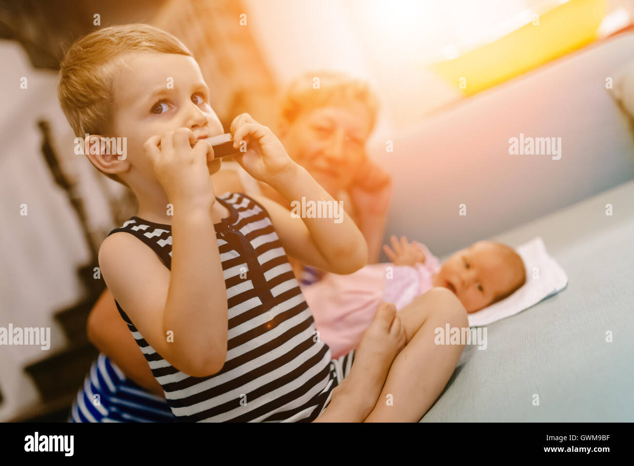 Cute toddler learning to play harmonica at home Stock Photo - Alamy