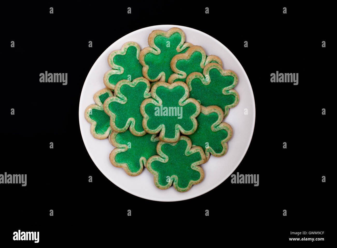 Shamrock shaped shortbread cookies with green sugar sprinkles on a ...