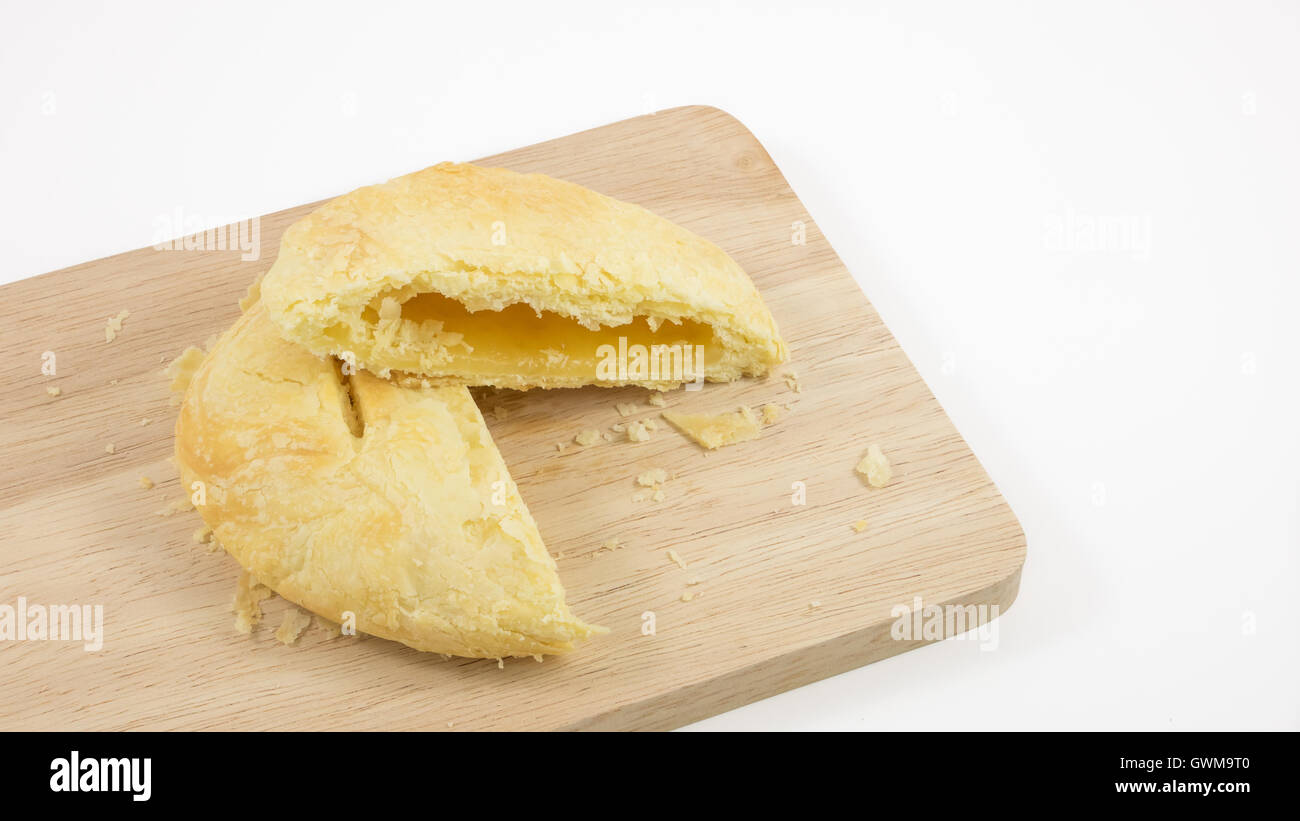 The Taiwanese sun cake (milk butter pastry) on the brown wooden plank ...