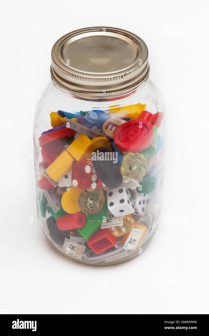 An old jar filled with a variety of old game pieces Stock Photo - Alamy