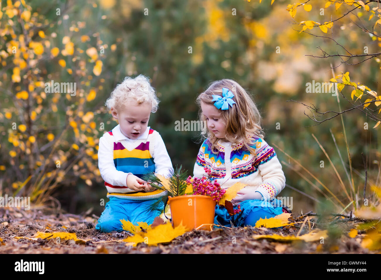 Happy children playing in beautiful autumn park on warm sunny fall day ...