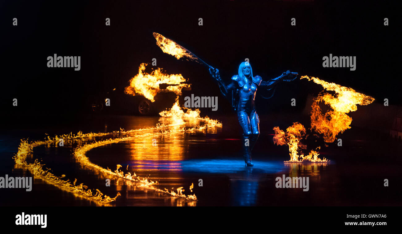 A woman with flamethrowers sets fire to a black car during Clarkson ...