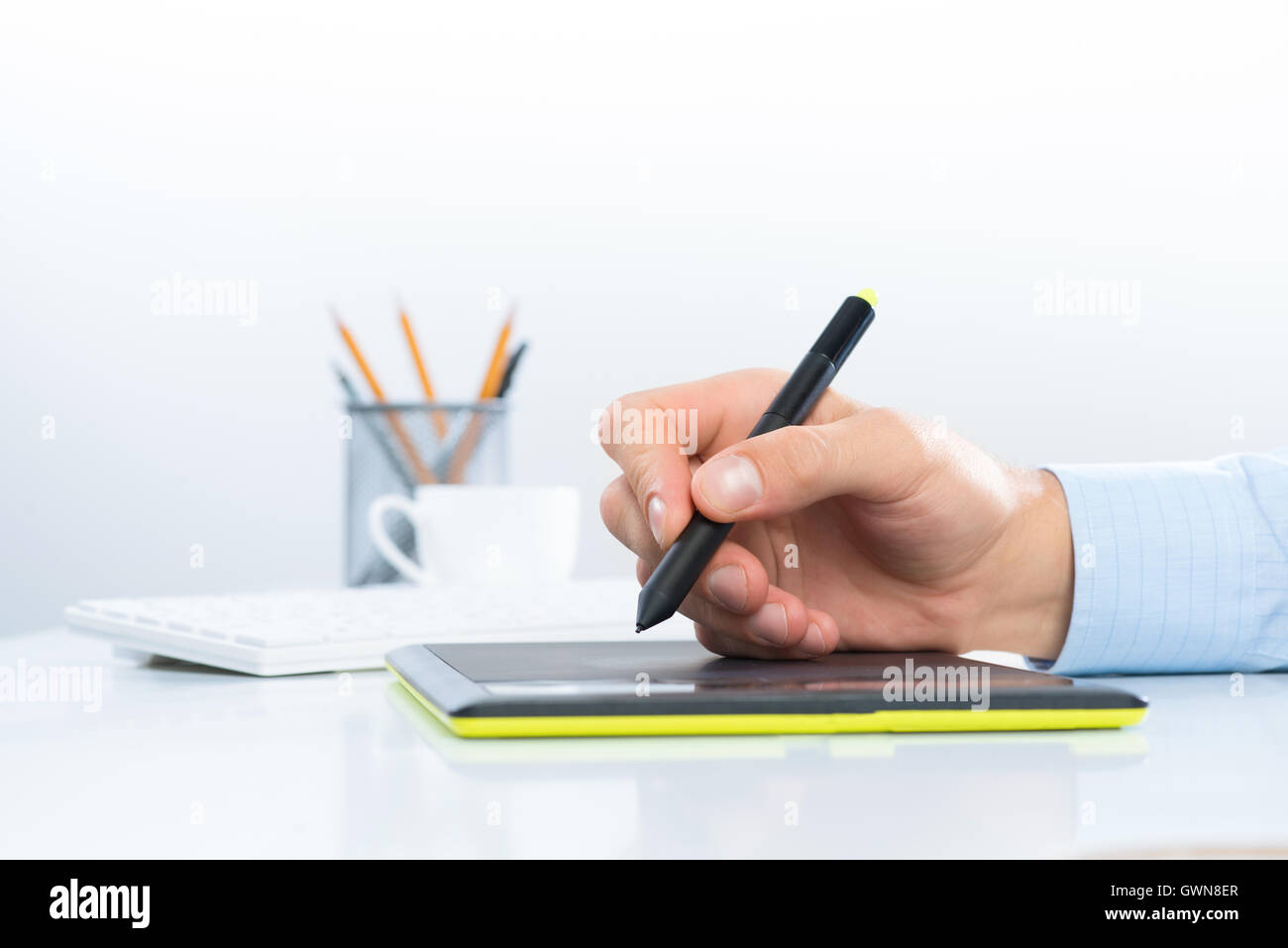 Designer hand drawing a graph on the tablet Stock Photo - Alamy