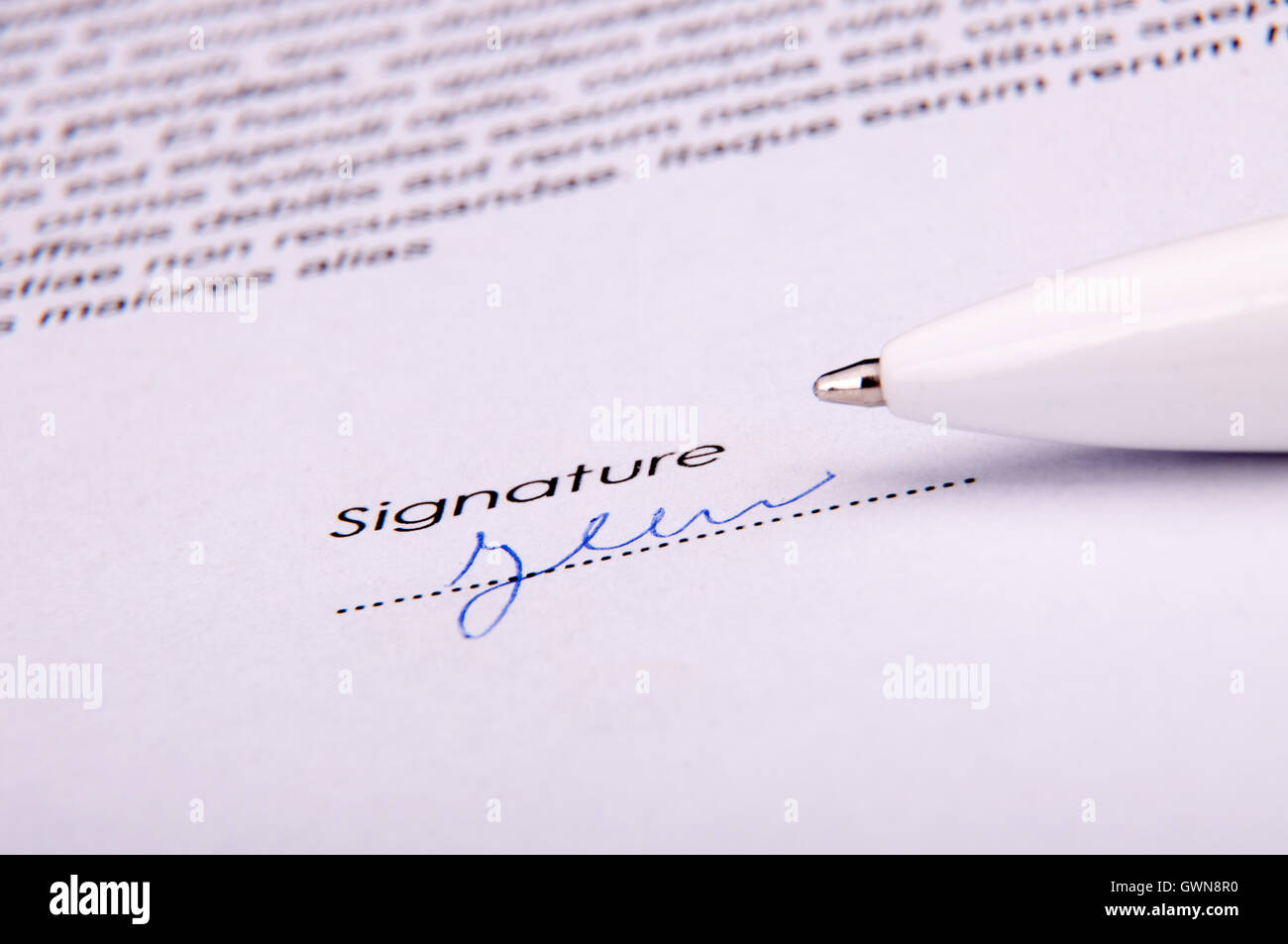 Signature over agreement Stock Photo - Alamy