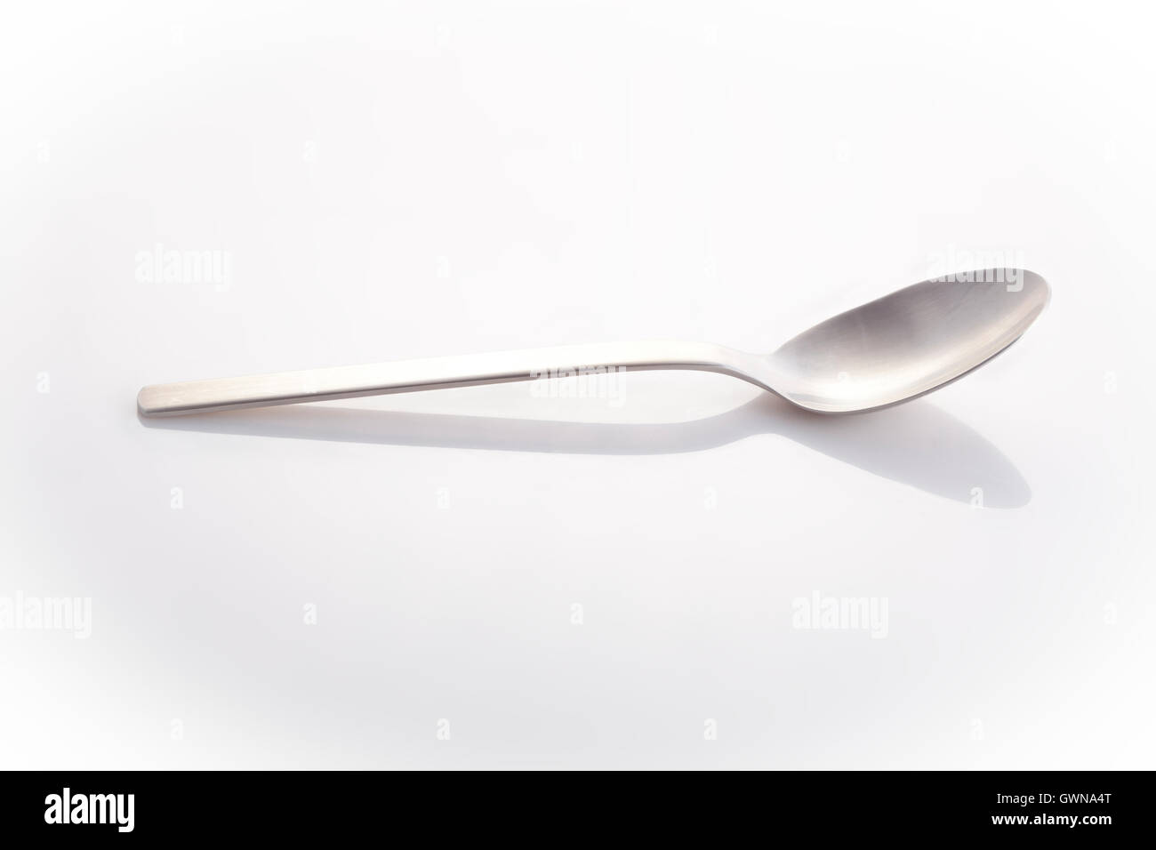 empty silver spoon isolated on a white background Stock Photo - Alamy