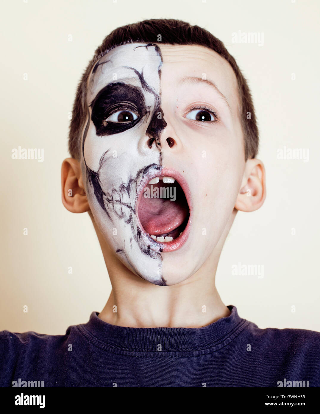 little cute boy with facepaint like skeleton to celebrate halloween ...