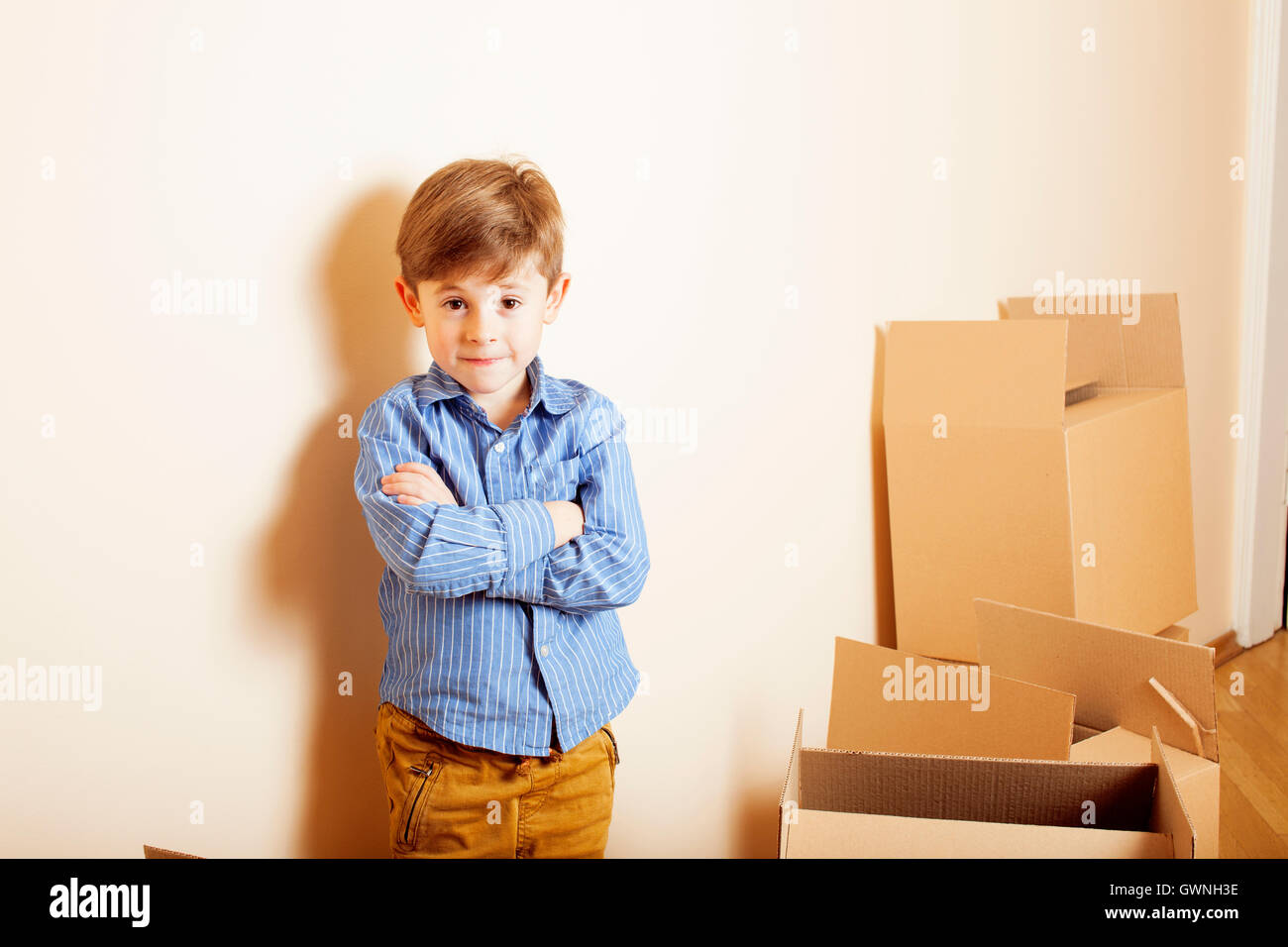 little cute boy in empty room, remoove to new house. home alone emong ...