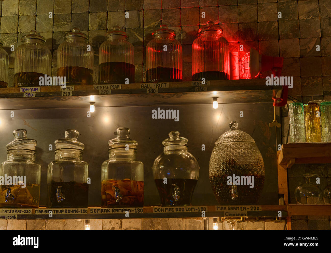 Jars of ya dong (Thai white spirits with medicinal herbs) at a bar in ...