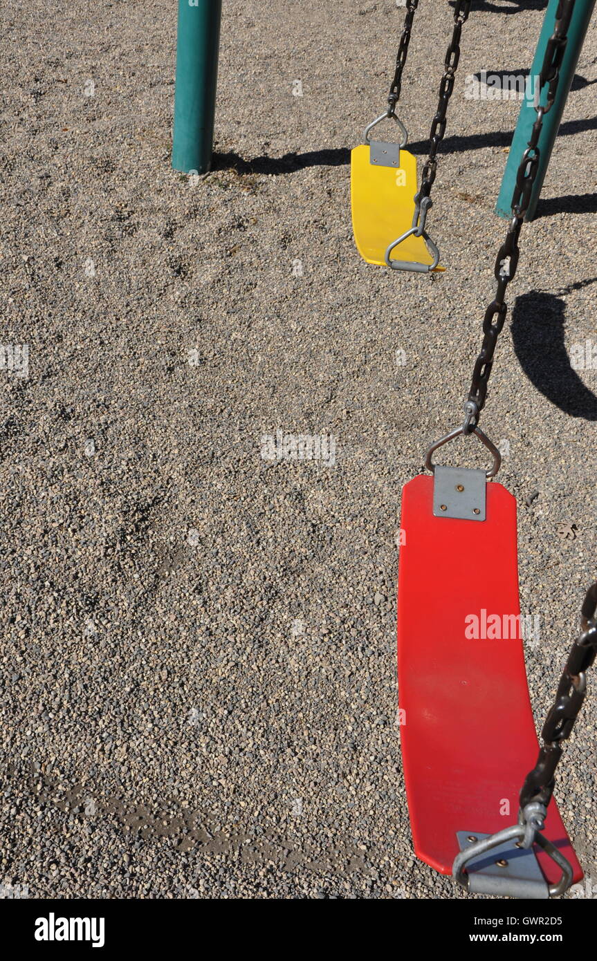 Two swings on a playground Stock Photo - Alamy