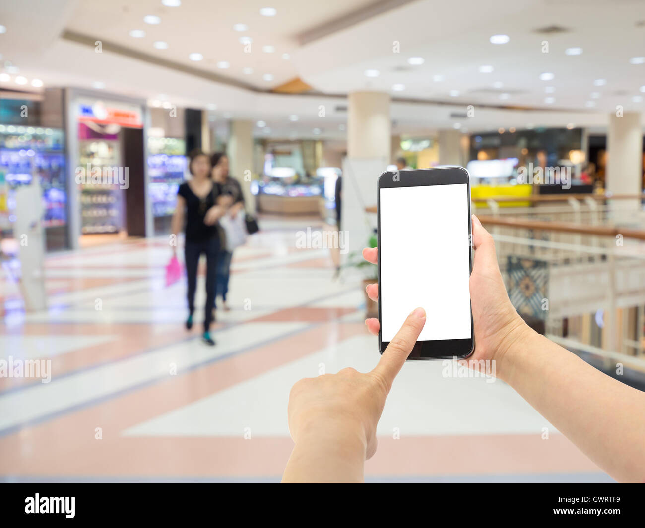 Woman's hands using smartphone in shopping mall Stock Photo - Alamy