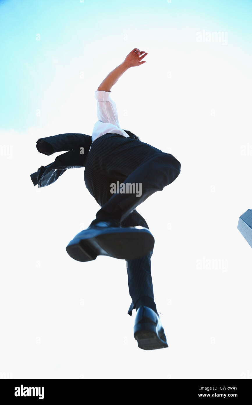 Young Japanese businessman jumping Stock Photo - Alamy