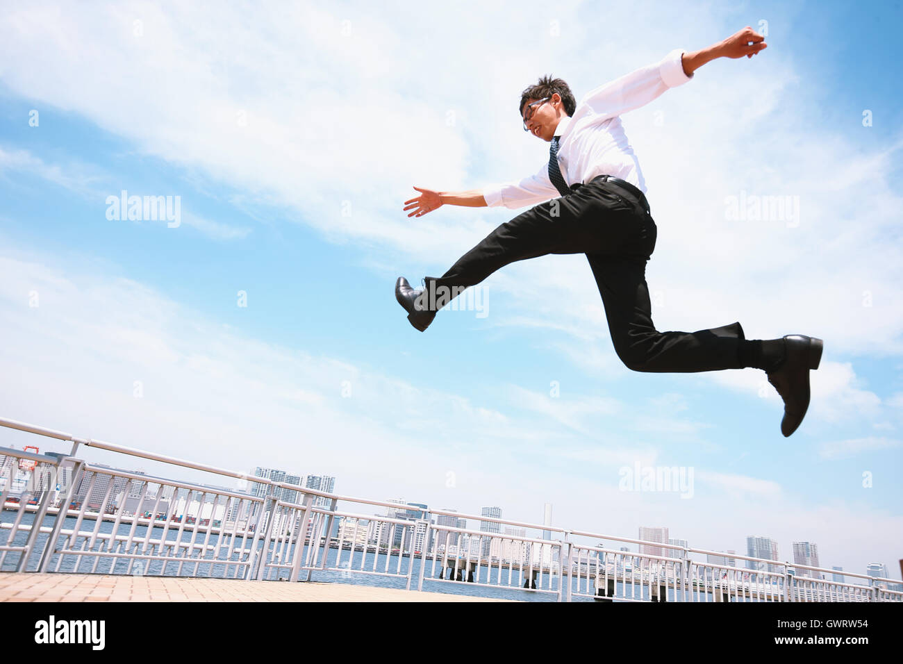Young Japanese businessman jumping Stock Photo - Alamy