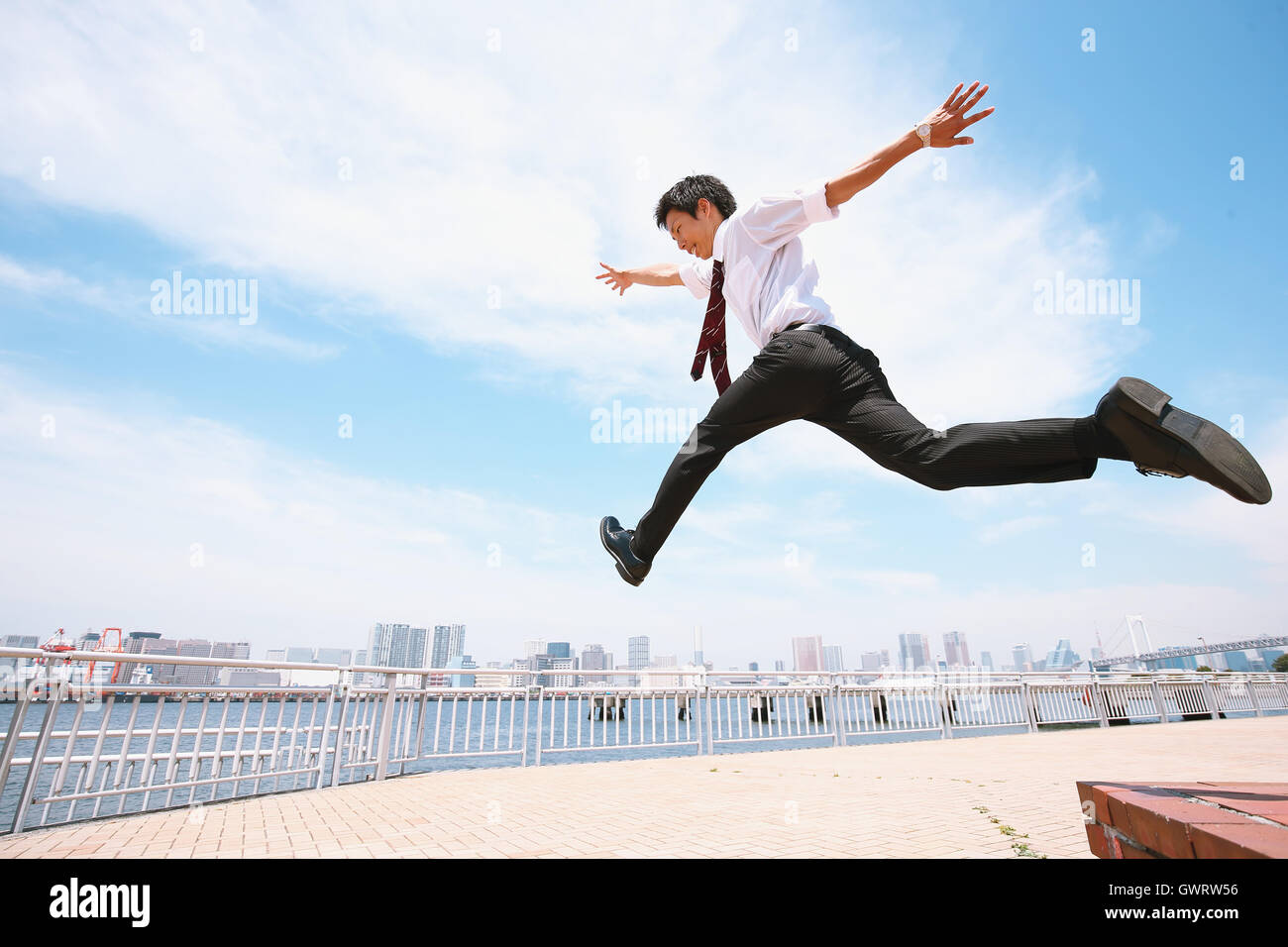 Young Japanese businessman jumping Stock Photo - Alamy