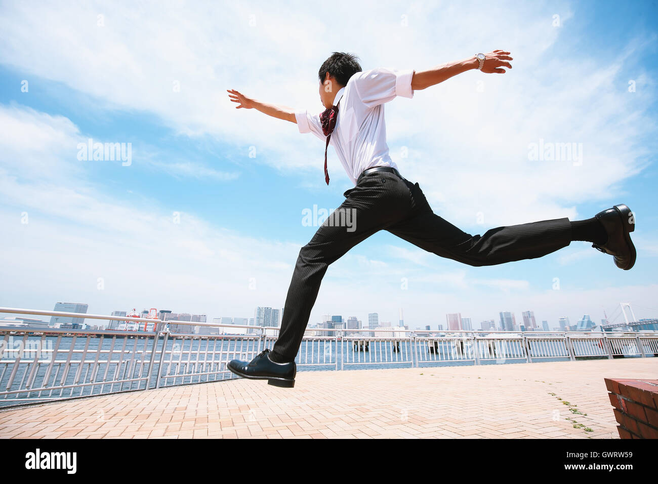 Young Japanese businessman jumping Stock Photo - Alamy