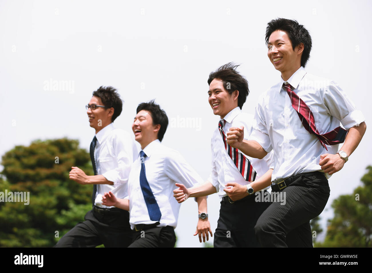 Young Japanese businessmen running Stock Photo - Alamy