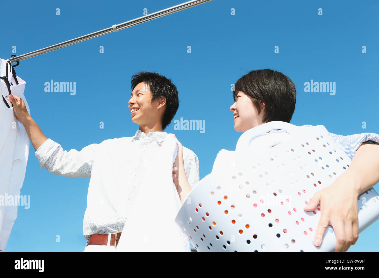 Young Japanese couple doing laundry Stock Photo - Alamy