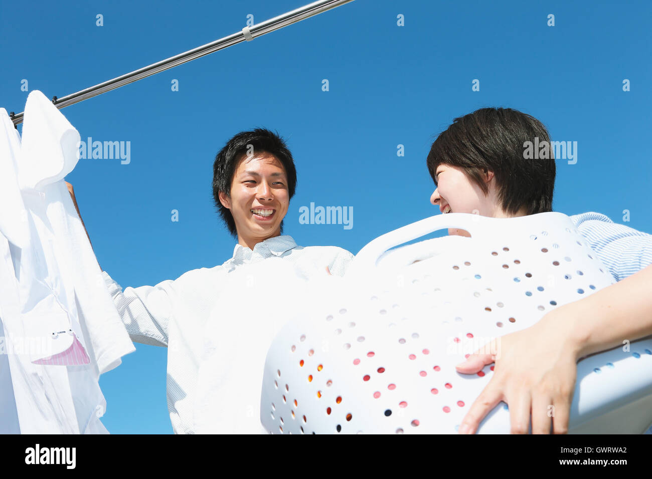 Young Japanese couple doing laundry Stock Photo - Alamy