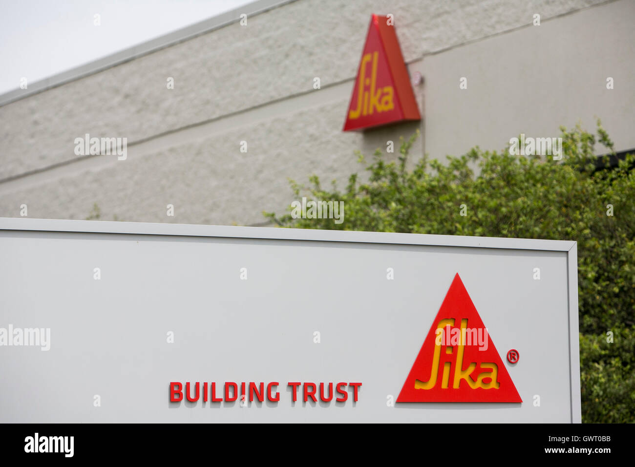 A logo sign outside of a facility occupied by the Sika Corporation in ...