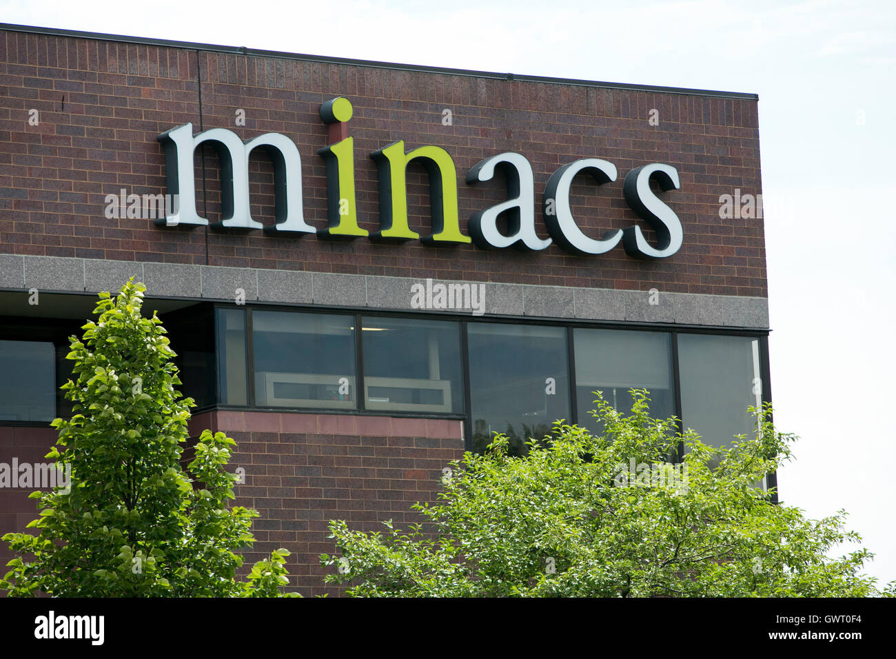 A logo sign outside of a facility occupied by Minacs in Farmington ...