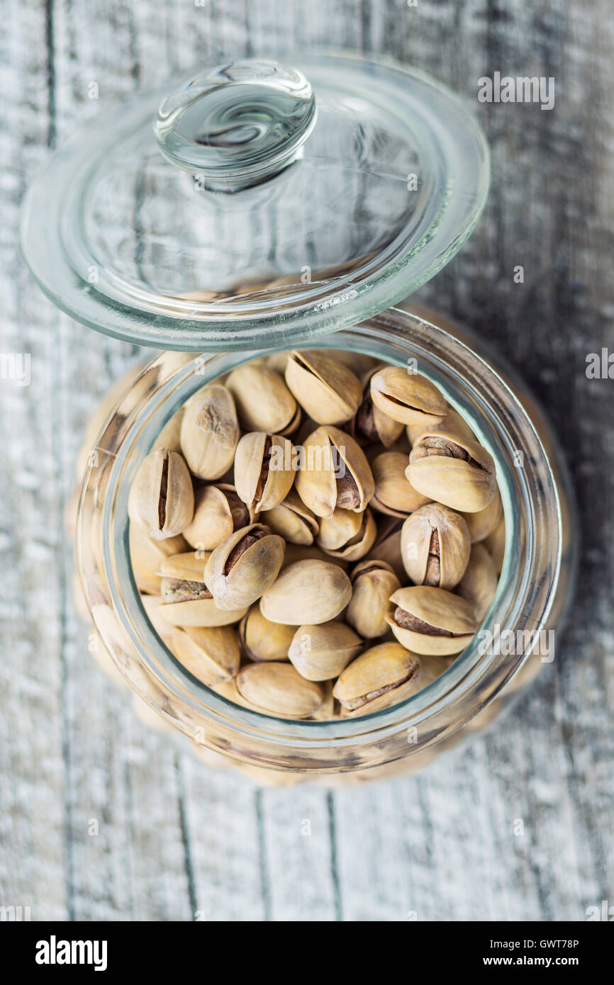 The pistachio nuts in jar. Top view Stock Photo - Alamy