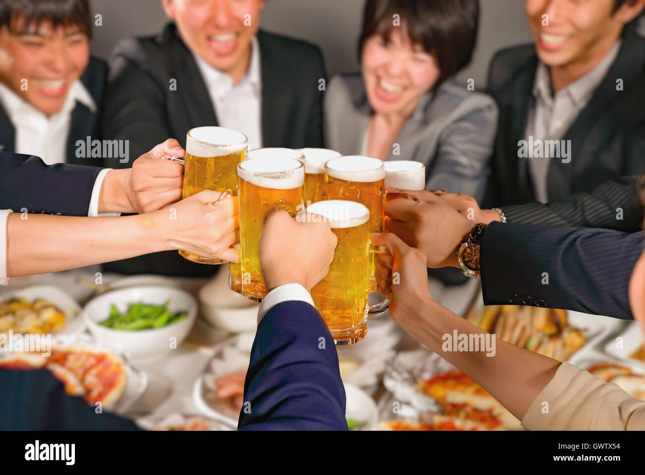 Group of young Japanese friends toasting with beer Stock Photo - Alamy