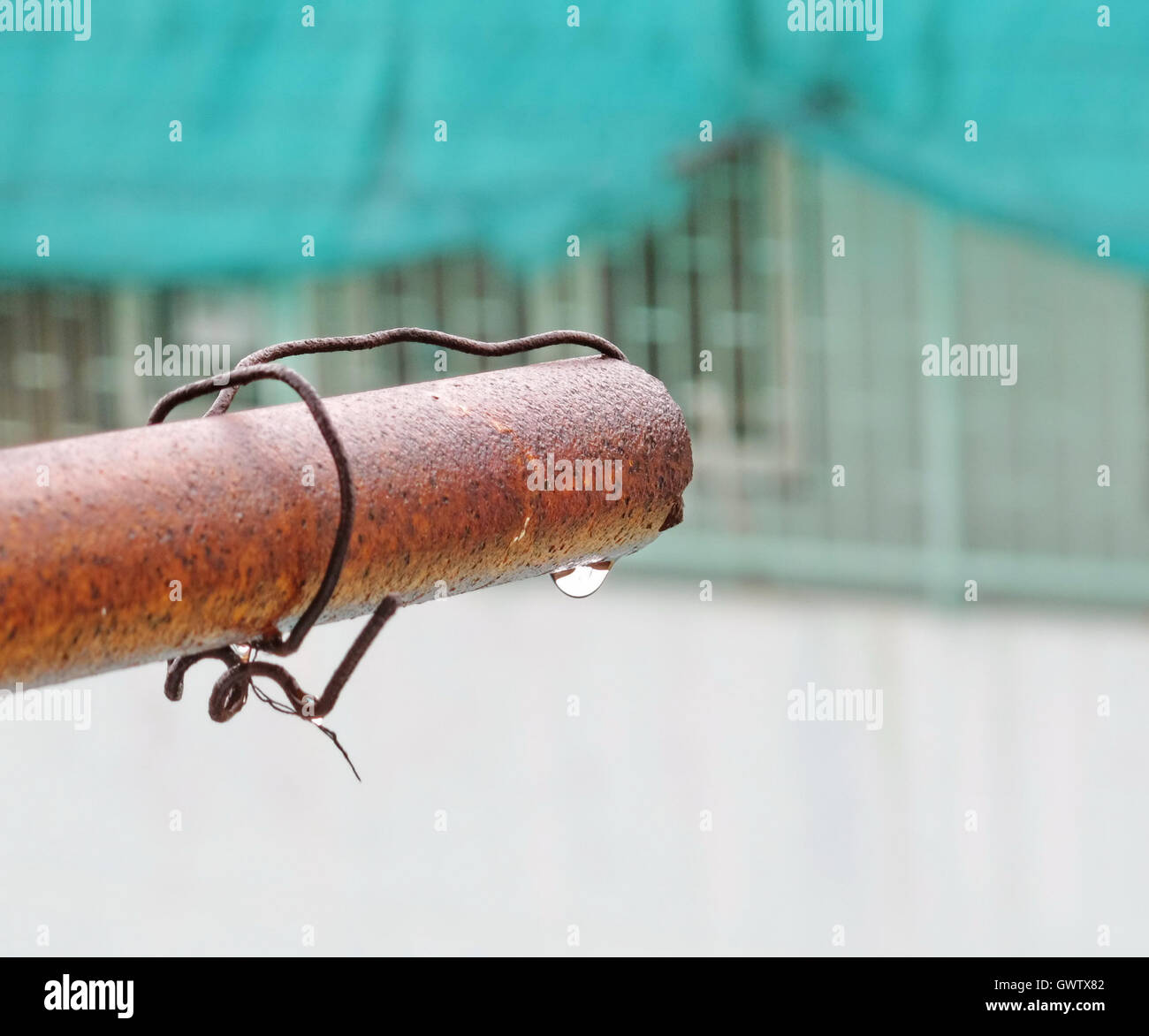 Water drop from metal pipe Stock Photo - Alamy