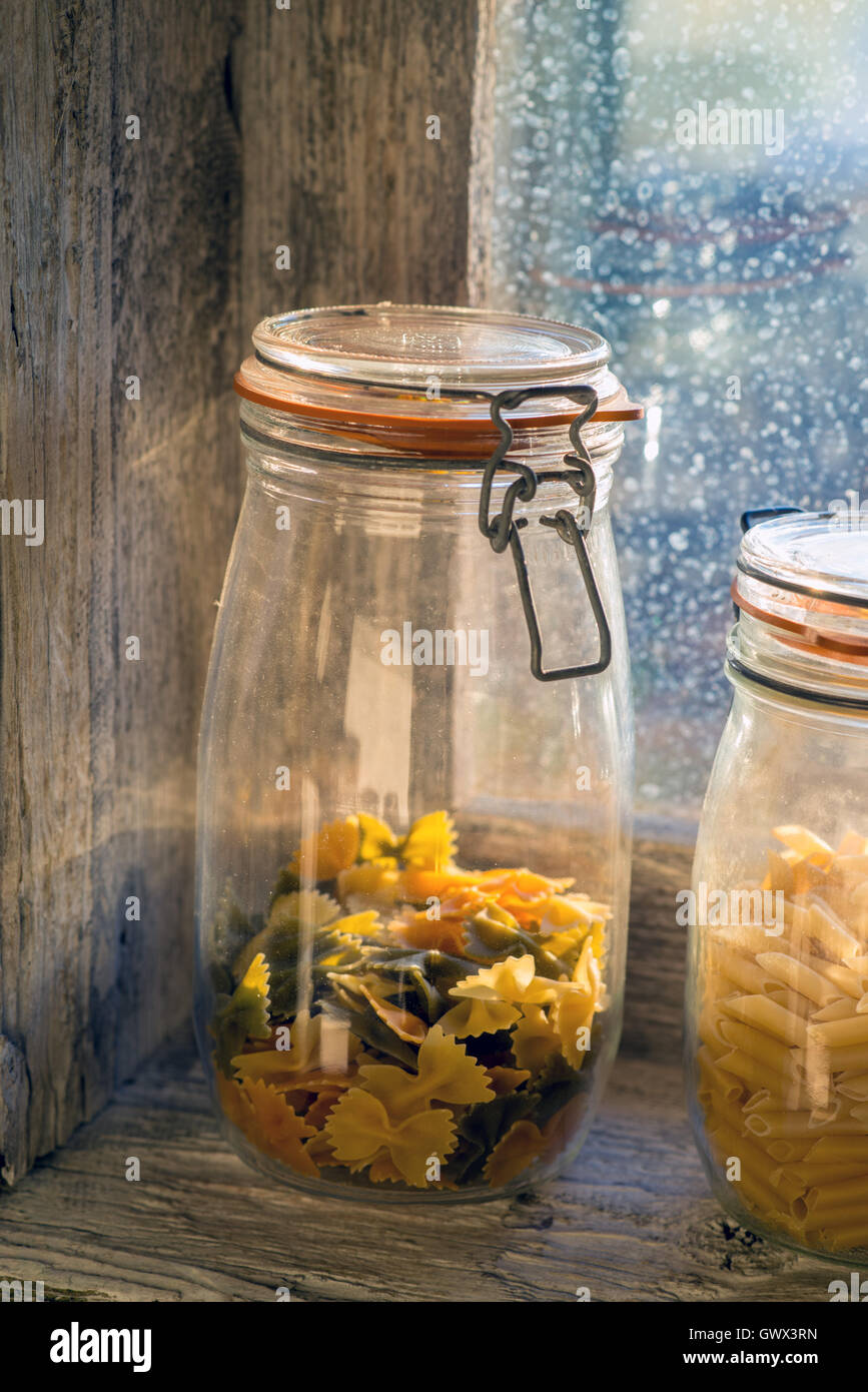 various raw pasta in a glass jar in a window sill Stock Photo - Alamy