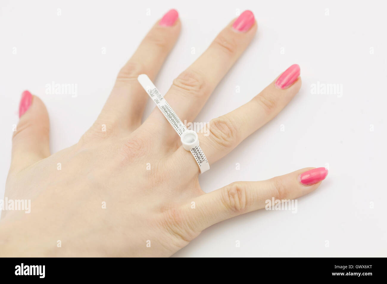 Female hand measuring a finger size Stock Photo - Alamy