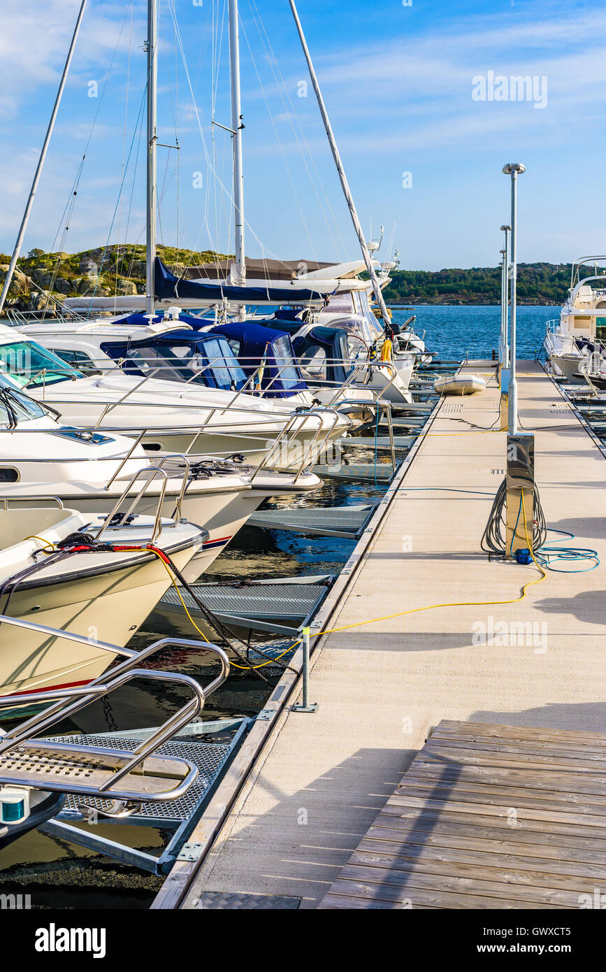 Floating pier in a marina with lots of boats moored at its side Stock ...